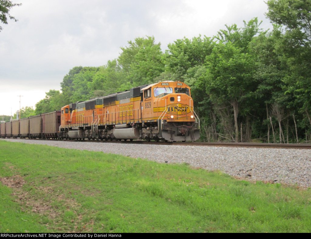 BNSF 8829 leads a coal train while clouds build up in the sky